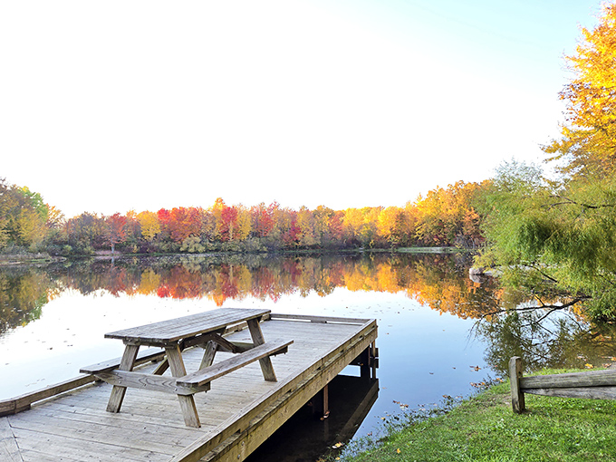 Nature's perfect mirror act! Fall foliage creates a double feature of color on Hidden Lake's glassy surface, with a picnic table perfectly positioned for front-row seats.