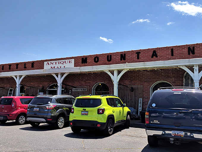 The brick façade with white columns isn't just charming—it's a time portal disguised as architecture. American flags flutter like welcome banners to treasure hunters.
