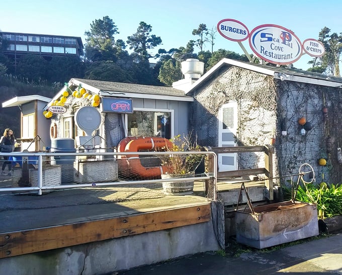 The unassuming exterior of Sea Pal Cove, where fishing nets and buoys aren't décor choices—they're authentic badges of honor from the working harbor.
