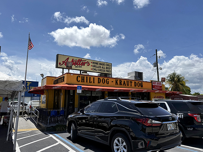 The bright yellow building with bold red awnings isn't trying to be subtle – it's proudly announcing that serious hot dog business happens here.