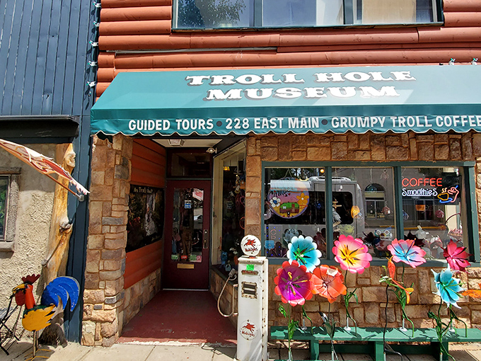 The unassuming storefront of Troll Hole Museum beckons with its cheery awning and colorful flowers, like a fairytale cottage hiding in plain sight on Main Street.