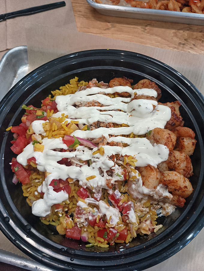 This seafood bowl is what happens when grilled perfection meets colorful companions – a harmony of flavors drizzled with creamy sauce.