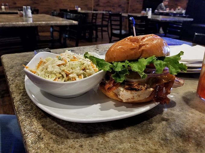 This burger isn't just topped with bacon—it's having a full-on love affair with it, and that coleslaw is playing matchmaker.