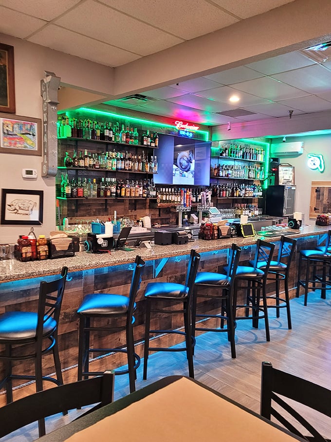 The bar area glows with promise, offering liquid companions to complement your smoky feast. BBQ and bourbon—a match made in Florida heaven.
