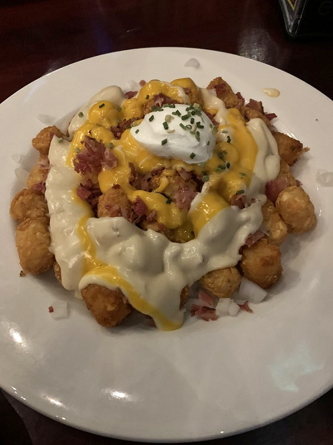 Tater tots elevated to art form. When cheese sauce, bacon, and sour cream join forces, resistance becomes entirely futile.
