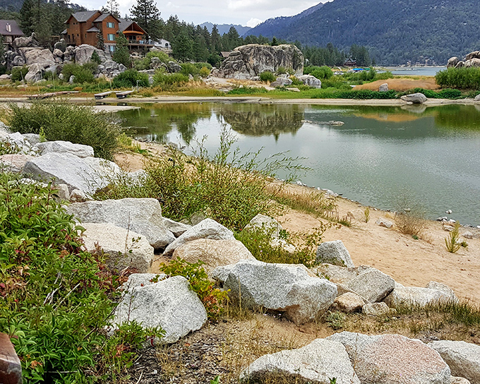 Boulder Bay's rocky shoreline creates natural sculptures that frame the lake's tranquil waters—nature's gallery requires no admission fee.