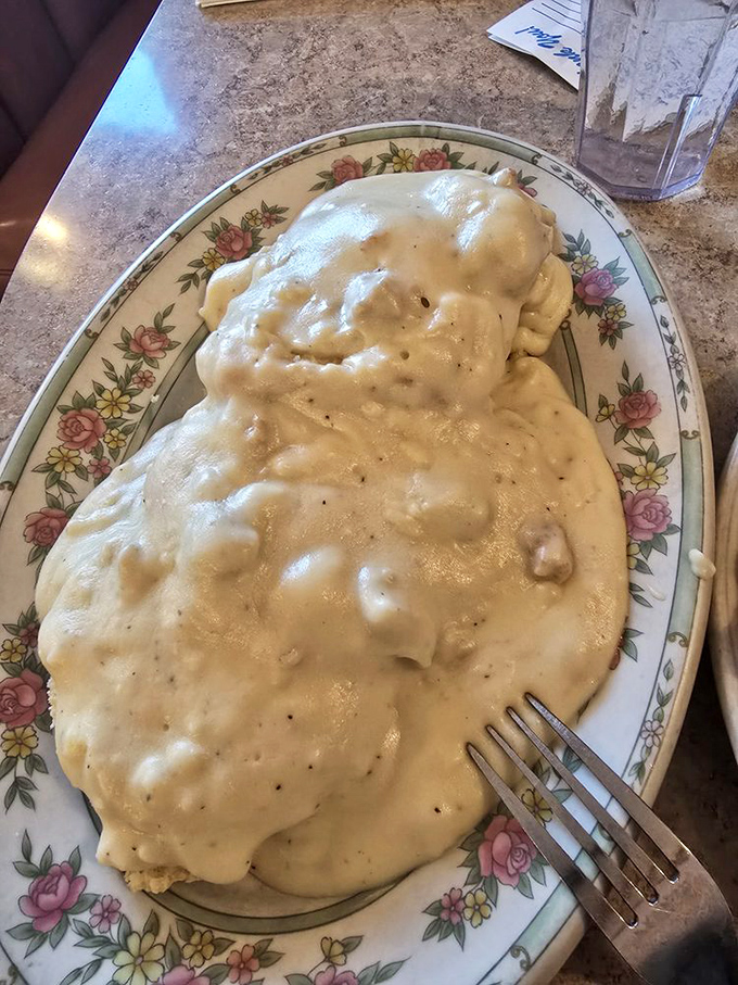 Biscuits smothered in country gravy—a dish so comforting it should come with a warning: "May induce spontaneous napping."