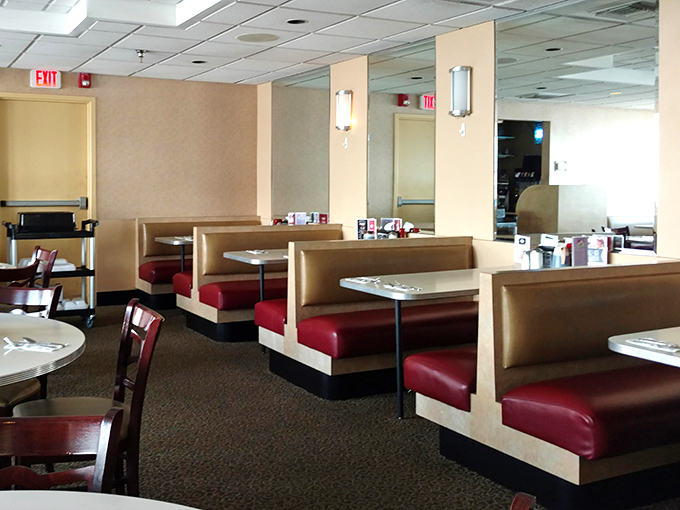 Classic diner booths where countless conversations, first dates, and food comas have unfolded—the red vinyl practically radiating decades of comfort.