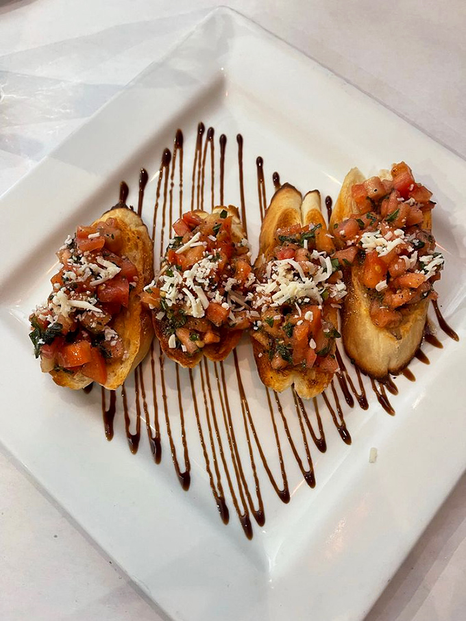 Bruschetta that celebrates simplicity—toasted bread topped with vibrant tomatoes, fresh herbs, and a shower of cheese. Summer on a plate.