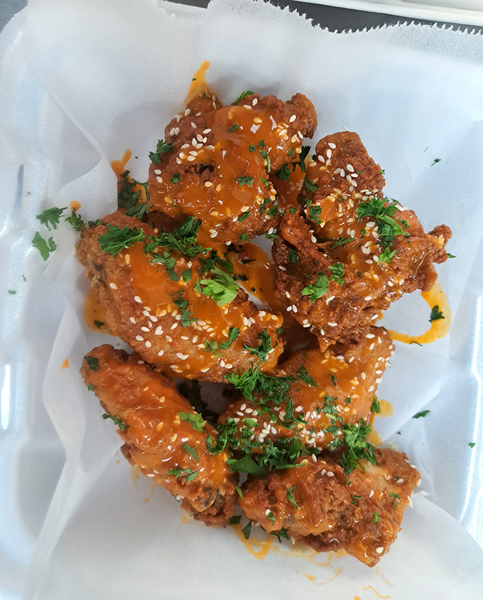 These aren't your average wings – they're flavor bombs disguised as chicken. The sesame seeds and fresh herbs elevate them to art form status.