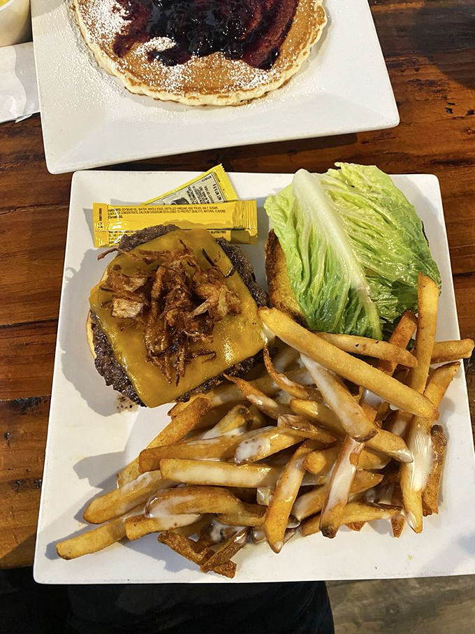 The burger doesn't care that it's at a breakfast joint—it's confident, cheese-draped, and accompanied by fries that refuse to be overshadowed.