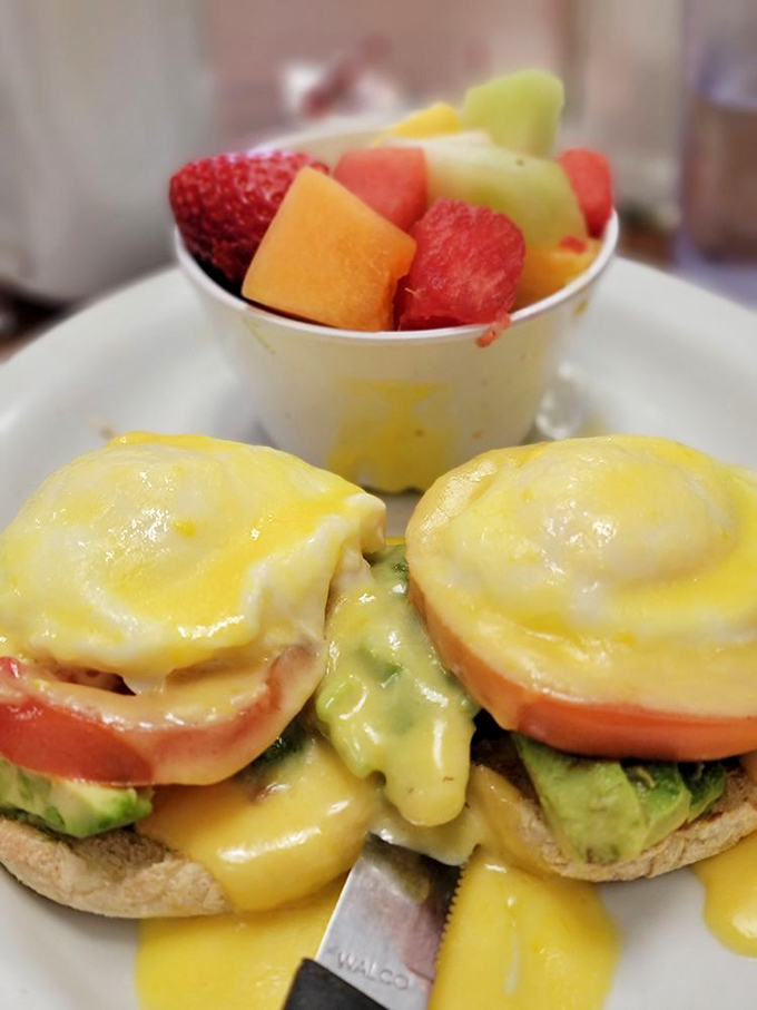 California Benedict with avocado—where East Coast tradition meets West Coast innovation in a hollandaise-draped masterpiece that defies breakfast boundaries.