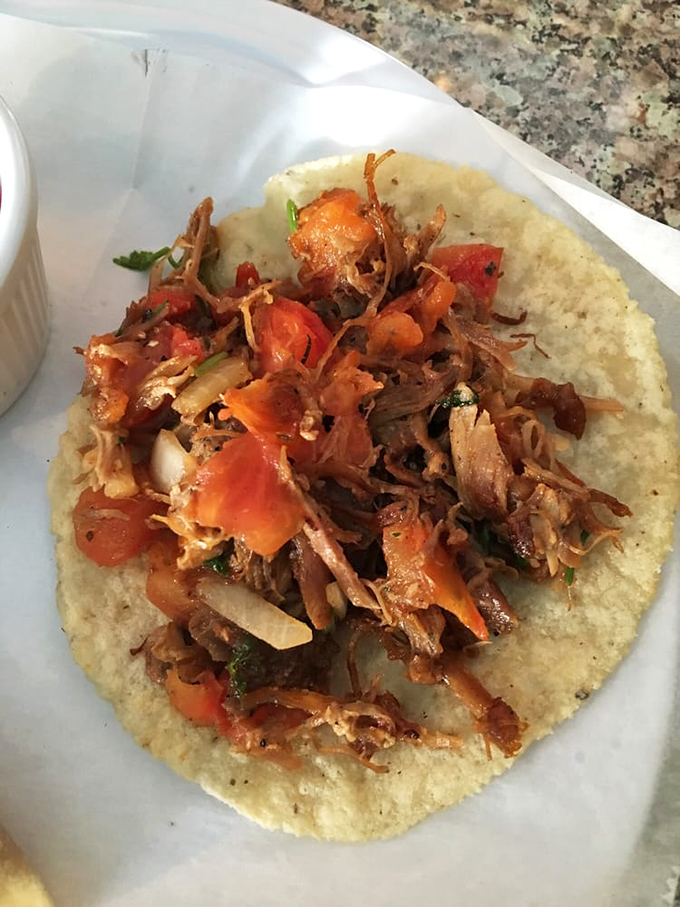 Carnitas tacos topped with fresh pico—the kind that make you wonder why you ever ate anything else.