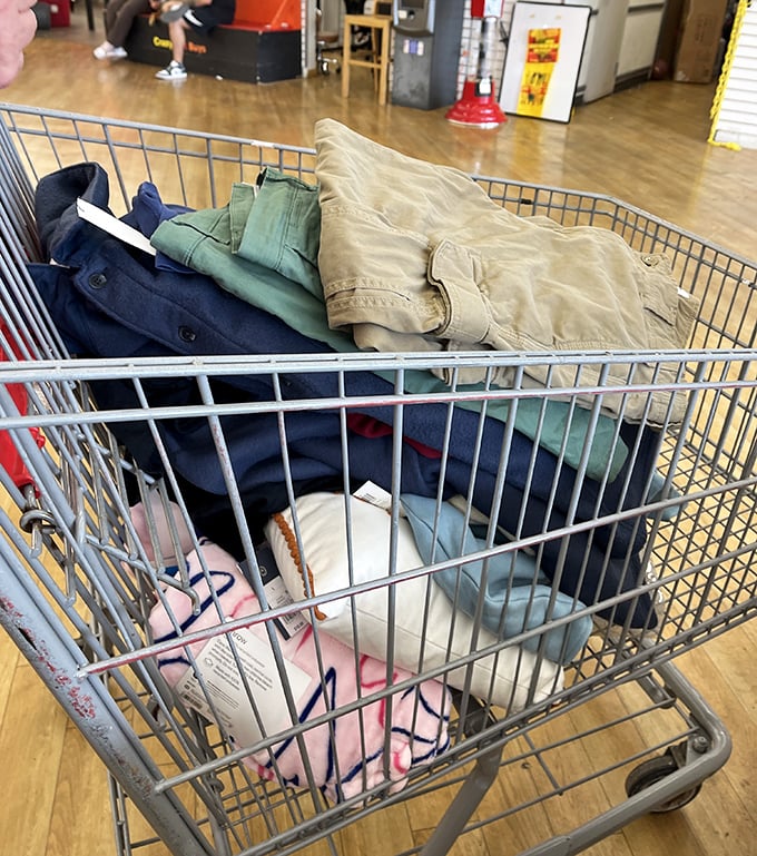 Cart contents tell shopping stories. This collection of earth-toned pants suggests someone's about to look fabulous for approximately one-fifth retail price.
