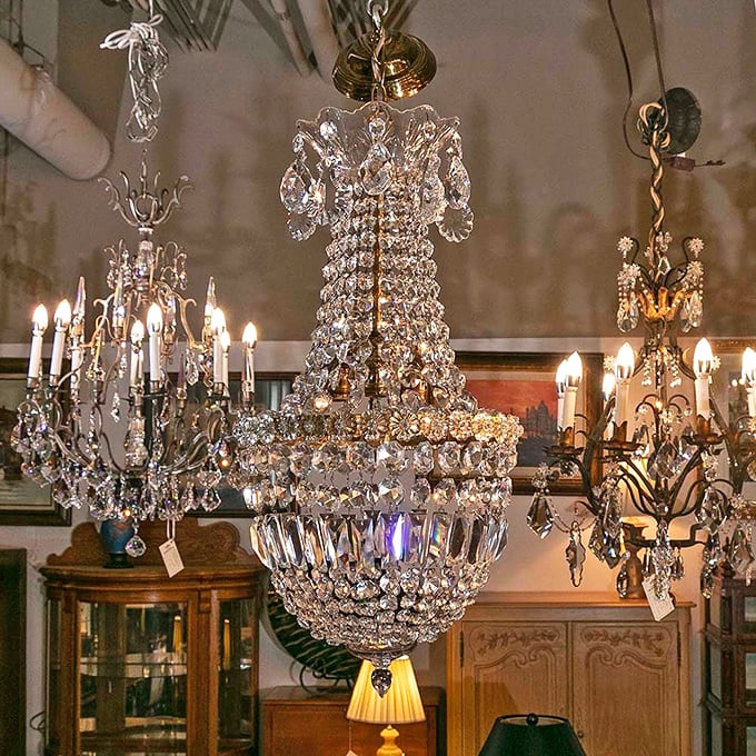 Crystal chandeliers hang like frozen fireworks, each one whispering tales of grand ballrooms and dinner parties where people definitely used the fancy silverware.