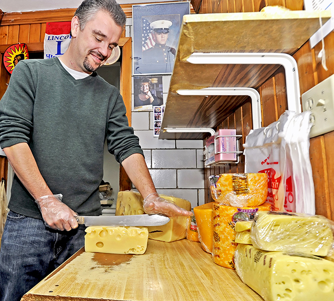 The cheese cutting station—where the magic happens. Those skilled hands have probably sliced more cheese than most people have seen. Photo credit: Shisler's Cheese House
