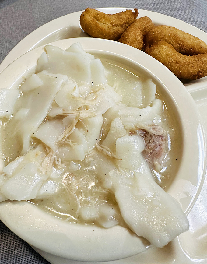 Chicken and pastry—the South's answer to chicken noodle soup. Pure comfort in a bowl with hush puppies standing by for dipping duty.