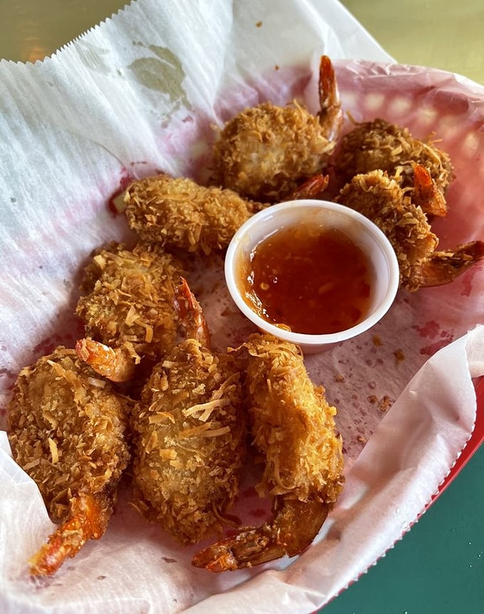 Coconut shrimp that crunch like walking on fresh snow, but taste like a tropical vacation—complete with sweet dipping sauce for the journey.