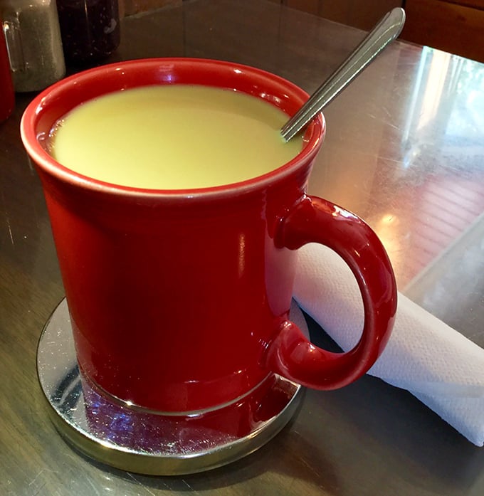 That vibrant red mug isn't just serving coffee—it's delivering liquid motivation for whatever mountain adventure awaits outside.