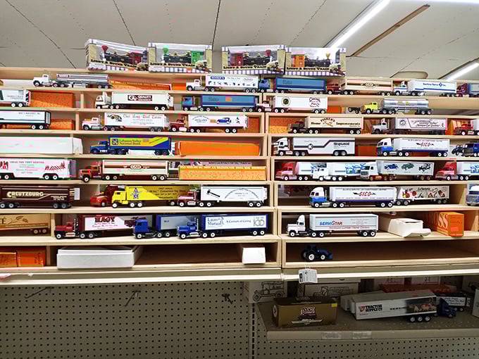 Miniature America on display! These collectible trucks chronicle decades of transportation history, lined up with military precision on wooden shelves.