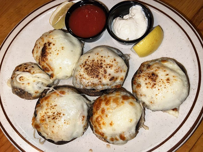 These mushrooms aren't just stuffed—they're overachievers, wearing melted cheese jackets and ready to start your meal with a standing ovation.