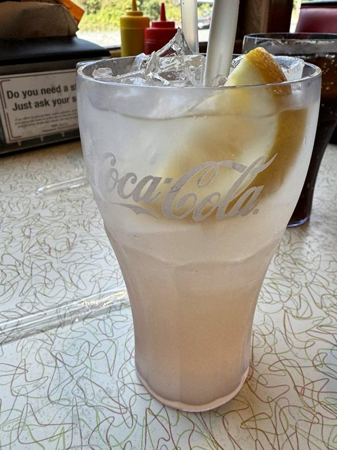 A frosty glass of what appears to be lemonade—the perfect counterbalance to a hearty burger. Refreshment, simplified.