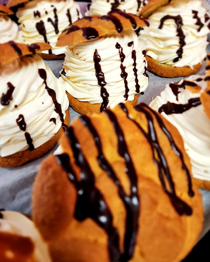 Cream puffs with chocolate drizzle that make you understand why people used to duel over desserts. Or should have.