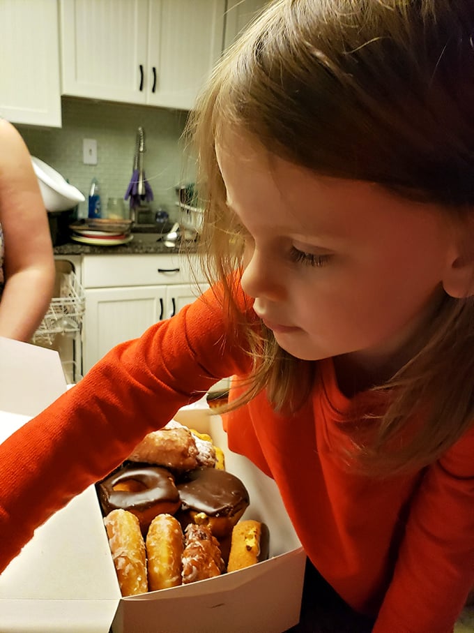 The magic moment when a child discovers the donut universe. That look of wonder says it all—life will never be quite the same again.