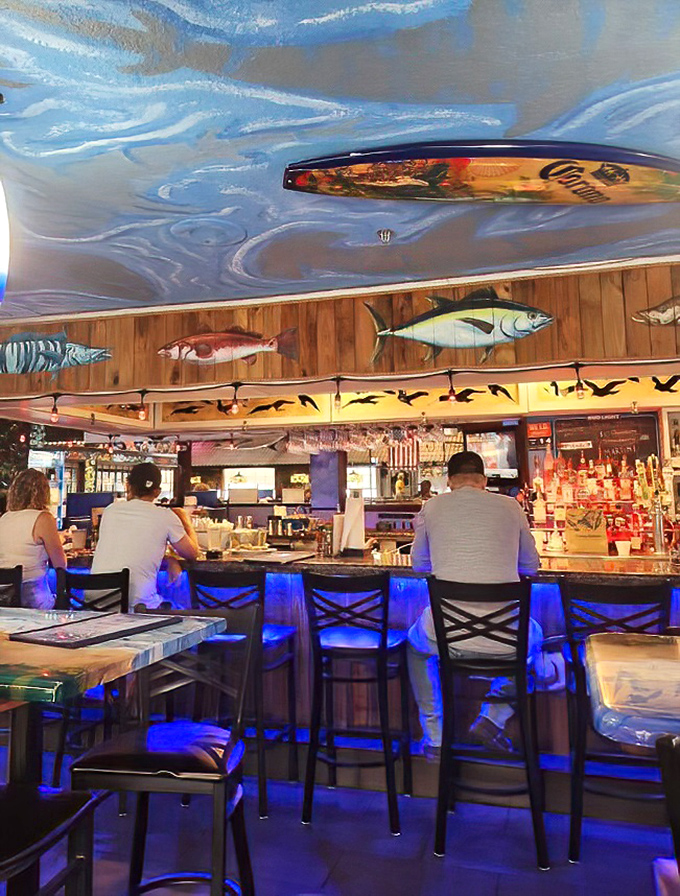 The bar area, with its surfboard-adorned ceiling and fish murals, captures Florida's coastal vibe without resorting to tacky beach clichés.