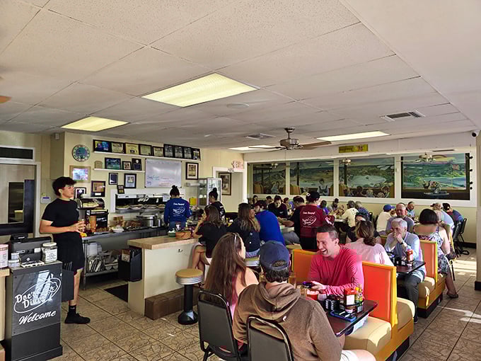 Locals and visitors alike gather around tables, creating the kind of community atmosphere that makes every meal special.