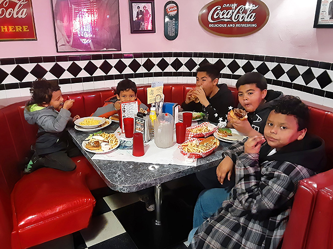 The classic booth experience: where families make memories between bites and kids learn the sacred art of milkshake appreciation.