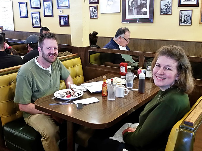 Happy diners caught in their natural habitat—the universal expression of people about to enjoy something delicious.