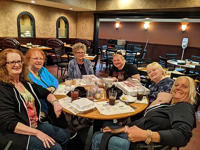 Where memories are made between bites—friends gathering around a table, proving that the best ingredient in any meal is the company you share it with.