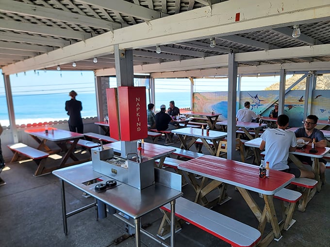 Diners enjoy their seafood feast under covered seating with those iconic coastal mountain views.