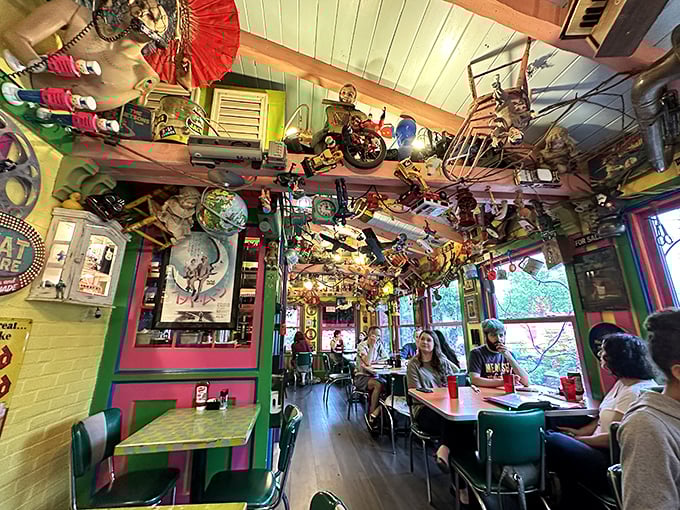 Even the ceiling is part of the conversation here. Diners eat beneath a museum of curiosities that would make any antique collector swoon.