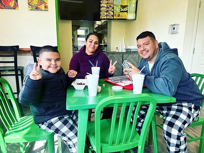 Happy diners making memories over meals. This is what it's all about—food bringing people together around a bright green table.