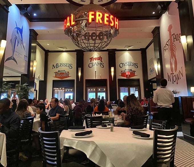Under the glow of "ALL FRESH" signage, diners gather for oceanic treasures. The bustling energy suggests they're all in on a delicious secret.