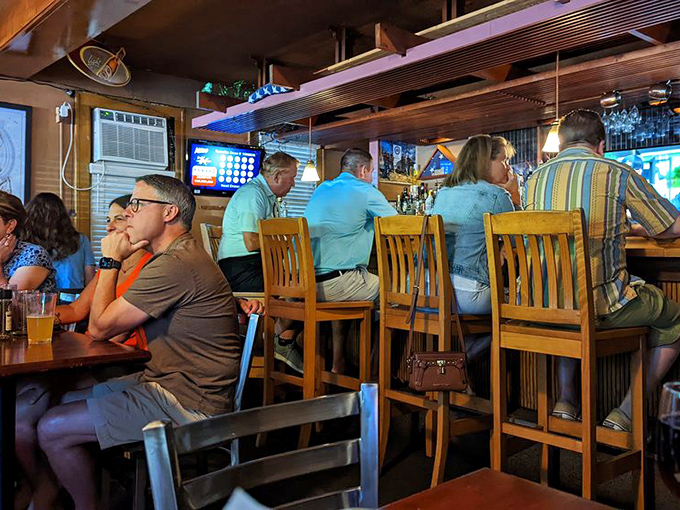 The universal language of good food bringing strangers together at a bar where conversations flow as freely as the drinks.