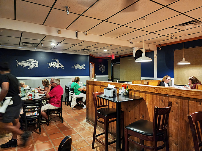 The blue wall with fish silhouettes reminds you what you're here for. Real people enjoying real food—what a concept!