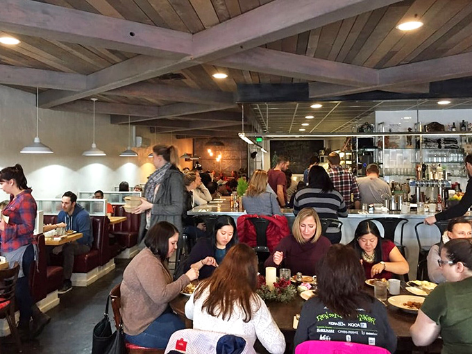 A full house of happy diners—the universal sign of "you've chosen wisely." The wooden beams frame a symphony of forks meeting plates.