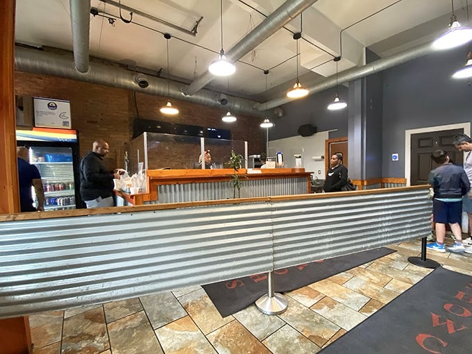 Where anticipation meets satisfaction. The ordering area's corrugated metal and exposed brick say, "We're serious about our barbecue, not our interior design."