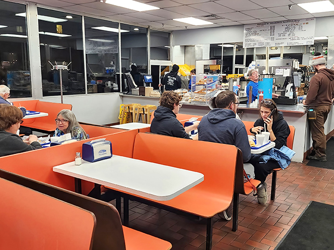 A typical lunch scene at Wilson's – where construction workers, office employees, and families all converge for the same simple pleasure: burger perfection without pretension.