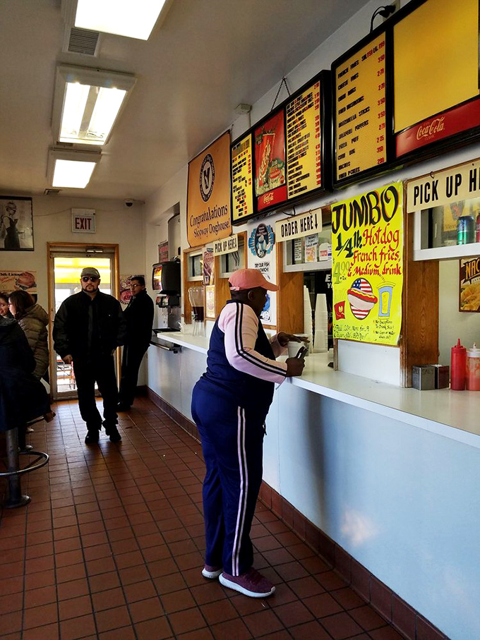 The lunch counter ballet—customers ordering, waiting, anticipating. Every Chicago neighborhood has a place like this where life's rhythms play out daily.