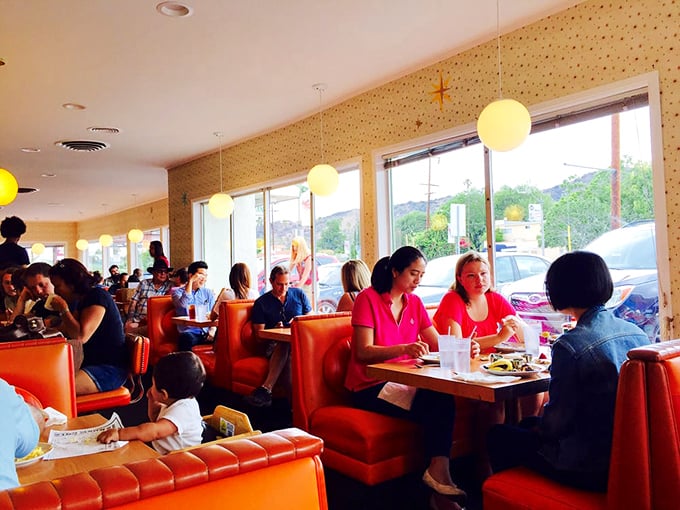 Where strangers become temporary breakfast companions. Notice how nobody's looking at their phones—the food demands full attention here.