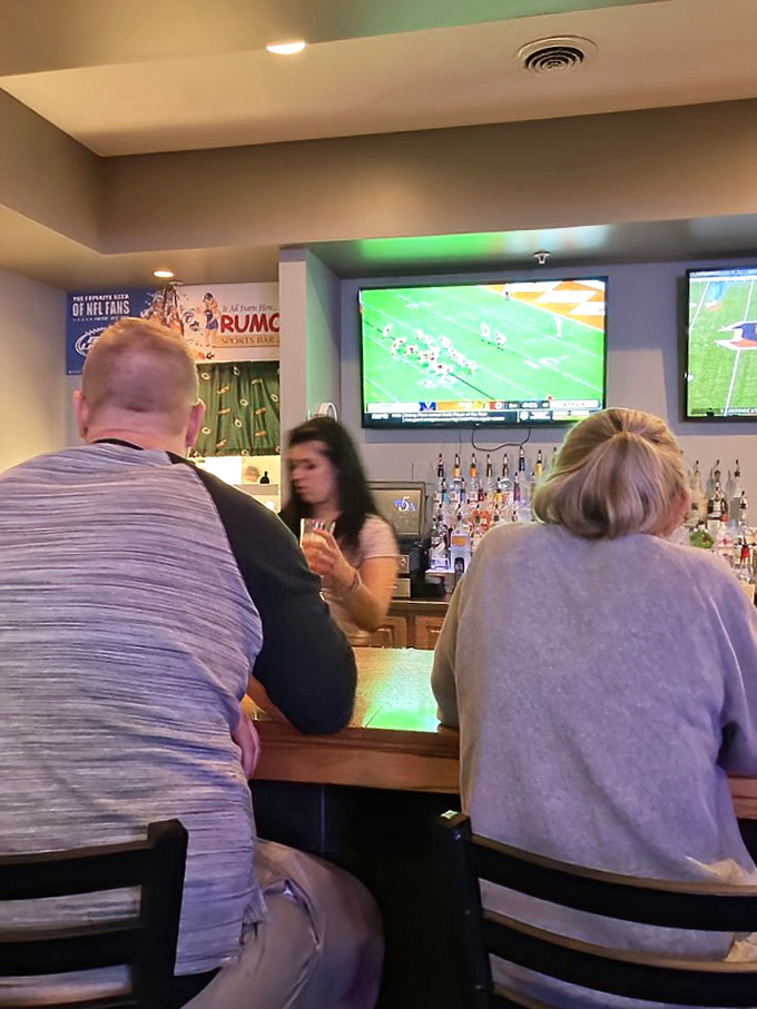The bar area during game time—where strangers become friends and friends become family, united by sports and good drinks.
