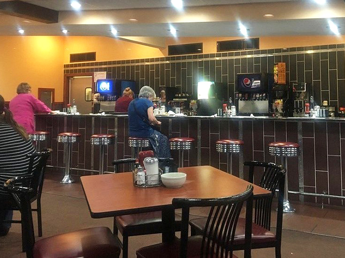 The classic diner counter—where solo diners find community, regulars claim their territory, and the coffee never stops flowing.