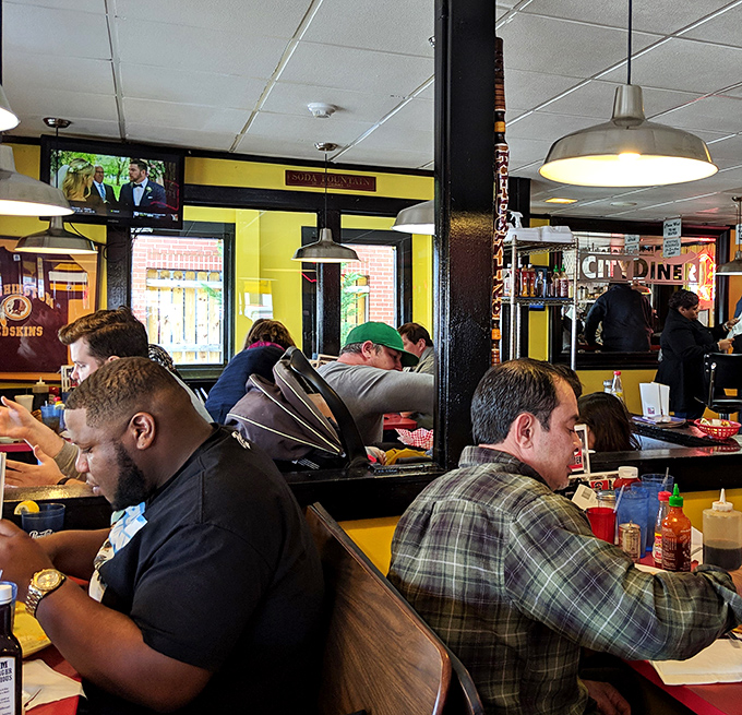 A diverse crowd of diners proves the universal appeal of good food—where suits and t-shirts coexist in perfect breakfast harmony.