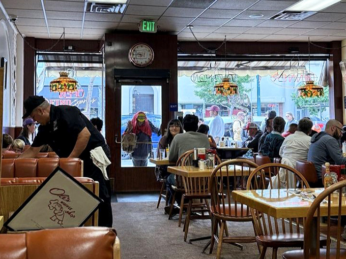 Morning democracy in action—diverse diners united by the universal language of good food, strong coffee, and the promise of a satisfying breakfast.