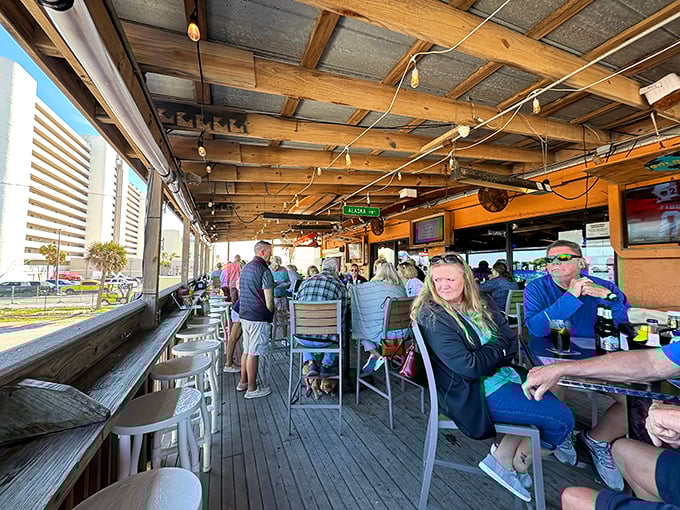 The outdoor deck at Lou's—where locals and tourists unite in the universal language of good food, cold drinks, and ocean views.