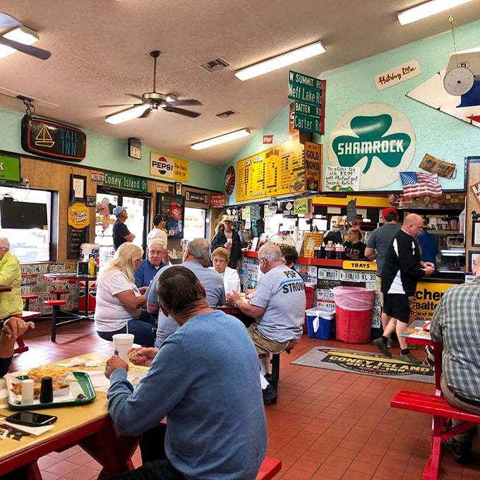 The lunch crowd knows the secret – this isn't just about the food; it's about the community that forms around these red tables and shared memories.